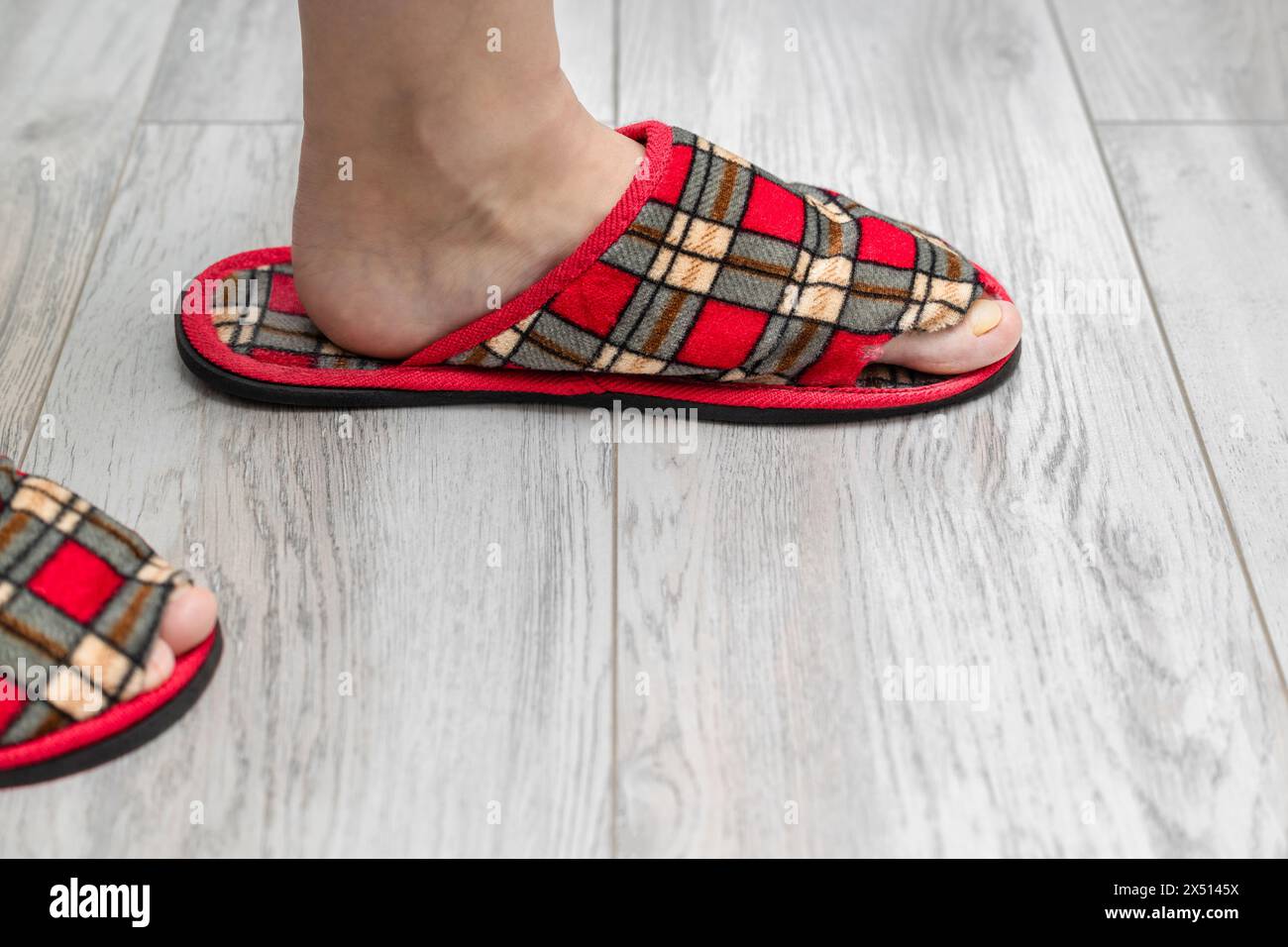 foot shod in an old leaky slipper. old slipper. holey sneaker. the toe ...