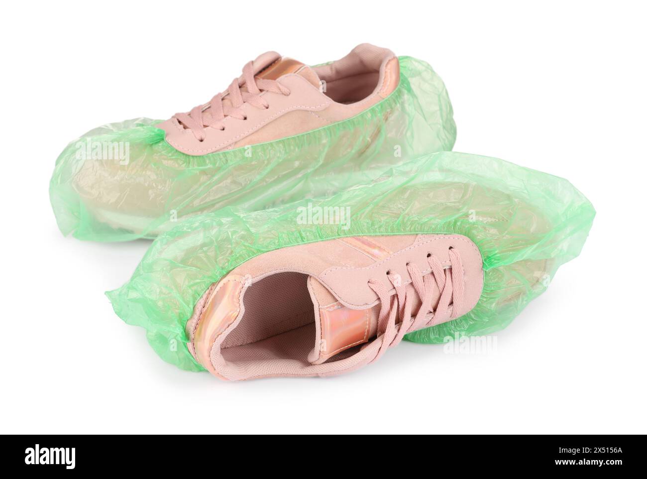 Sneakers in green shoe covers isolated on white Stock Photo - Alamy