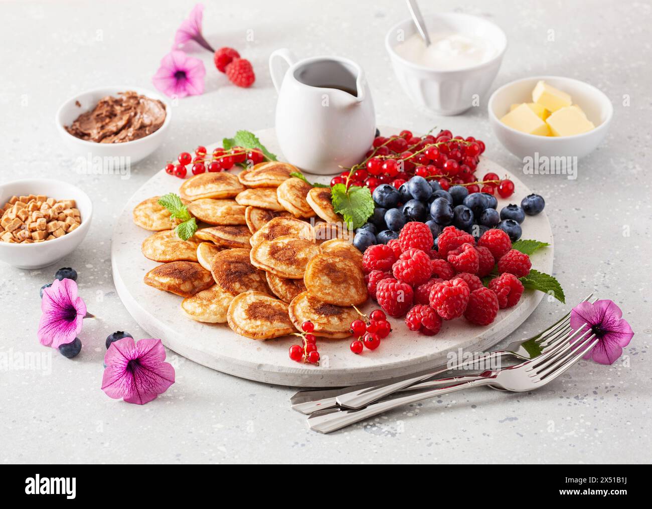 american mini pancake board with berries and maple syrup Stock Photo ...