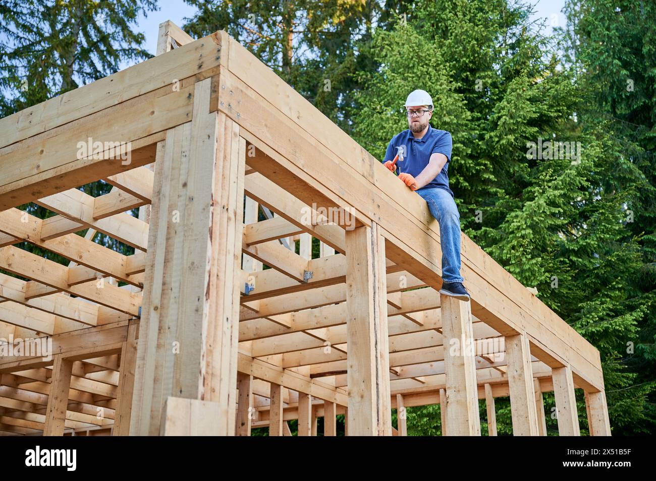 Joiner erecting wooden, two-story, frame-built dwelling adjacent to the ...
