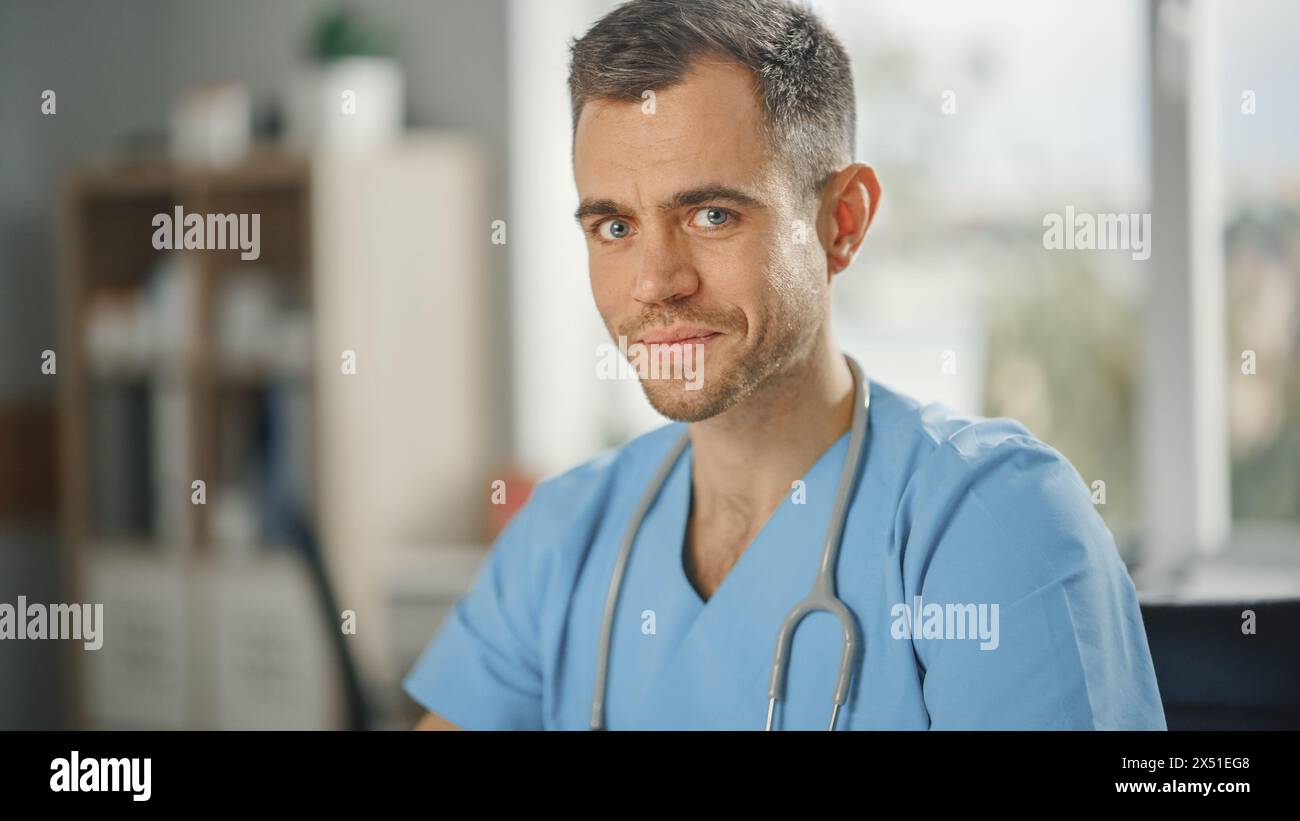 Portrait of Experienced Male Nurse Wearing Blue Uniform Smiling at ...