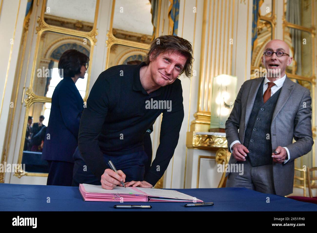 Robinson Latour signs the donation order during the ceremony of ...