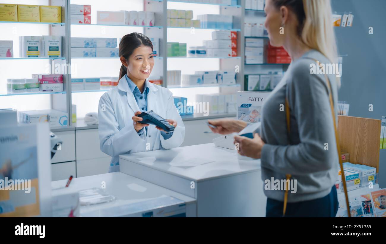 Pharmacy Drugstore Checkout Cashier Counter: Professional Asian Female ...