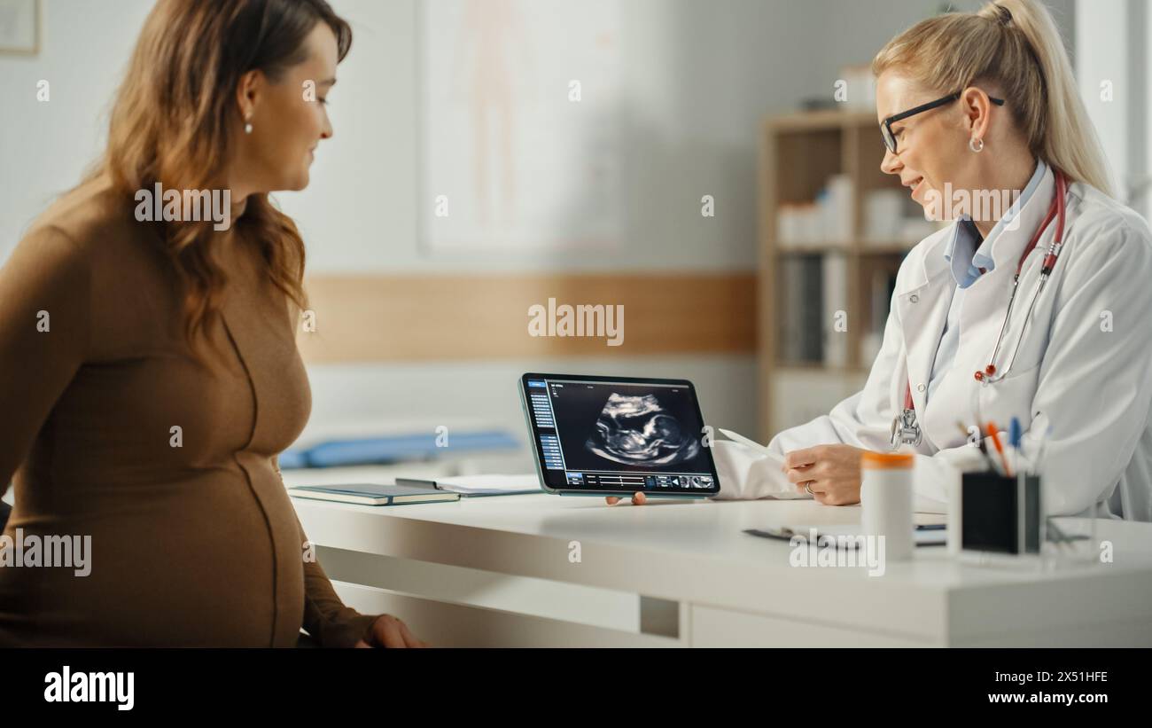 Female Physician Showing Tablet Computer with Ultrasound Pregnancy Scan ...