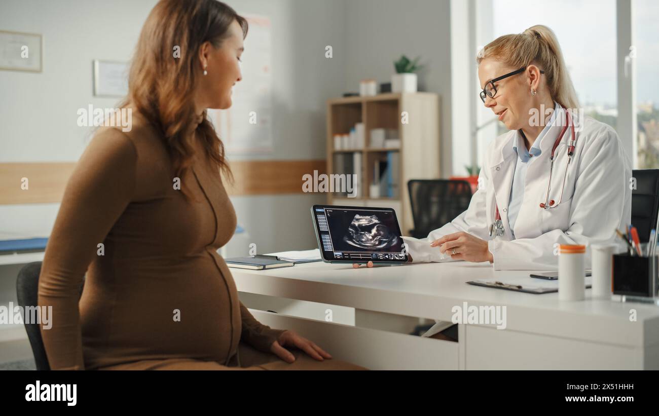 Female Physician Showing Tablet Computer with Ultrasound Pregnancy Scan ...