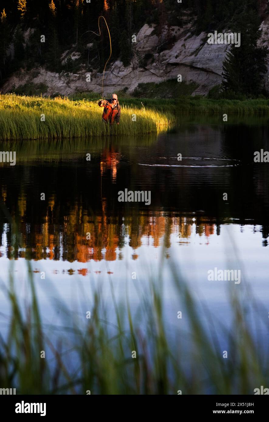 An angler casts to rising fish Stock Photo - Alamy