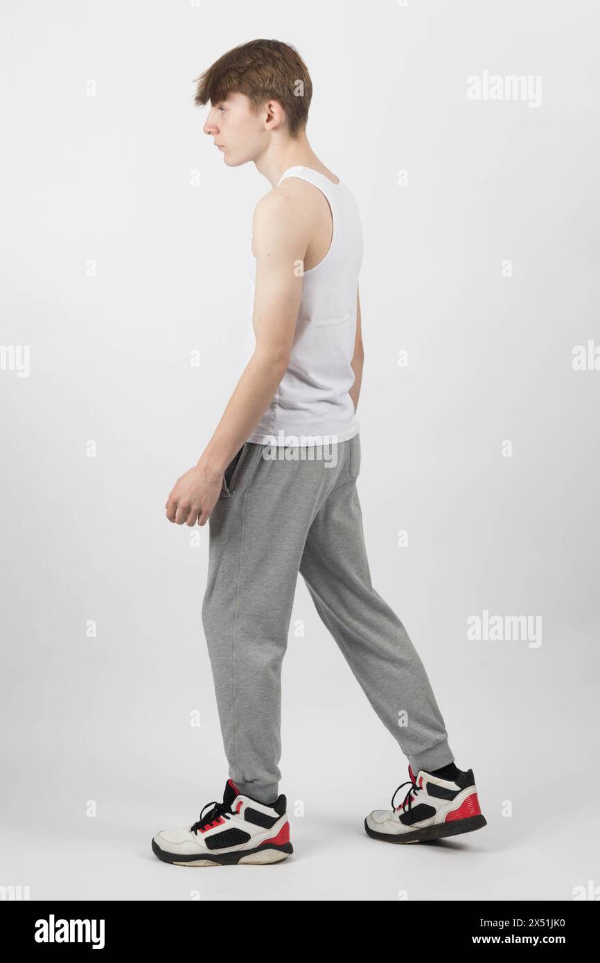 A Fifteen Year Old Teenage Boy Standing Against A White Background ...