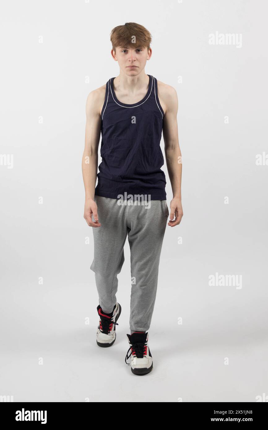 A Fifteen Year Old Teenage Boy Standing Against A White Background In A ...