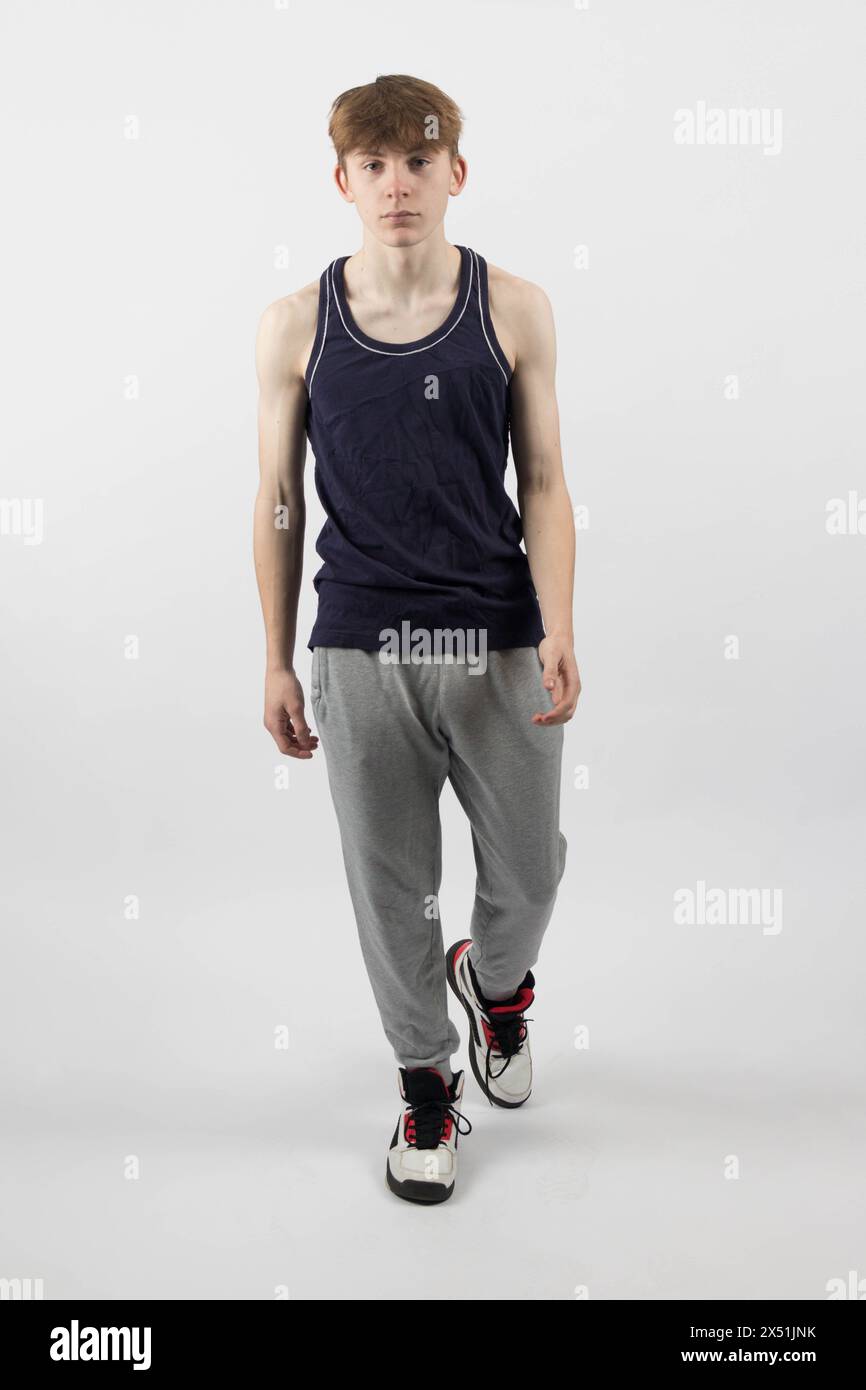 A Fifteen Year Old Teenage Boy Standing Against A White Background In A ...