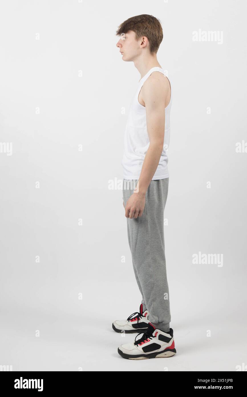 A Fifteen Year Old Teenage Boy Standing Against A White Background Facing To The Side Stock ...