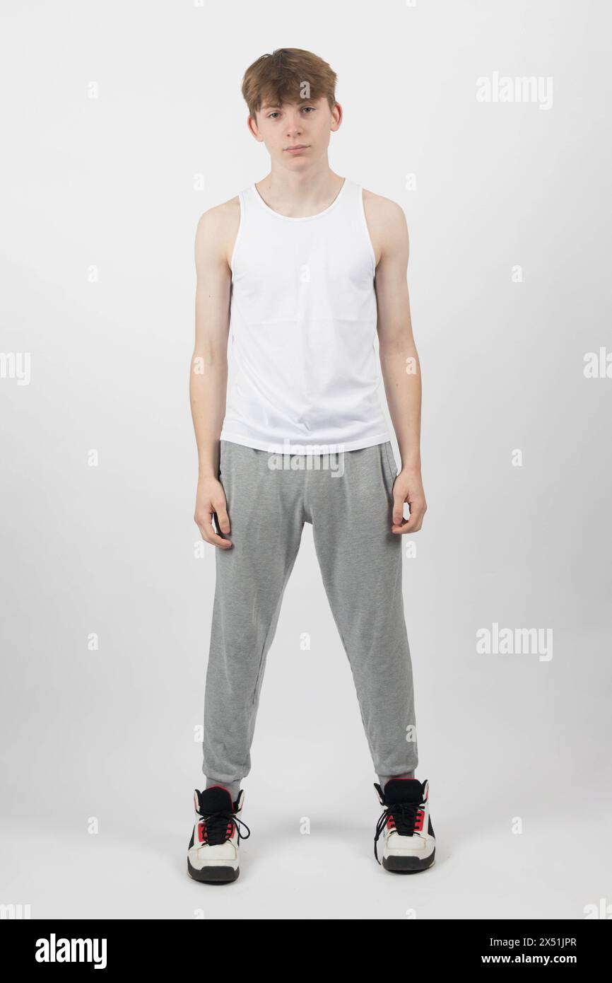 A Fifteen Year Old Teenage Boy Standing Against A White Background ...