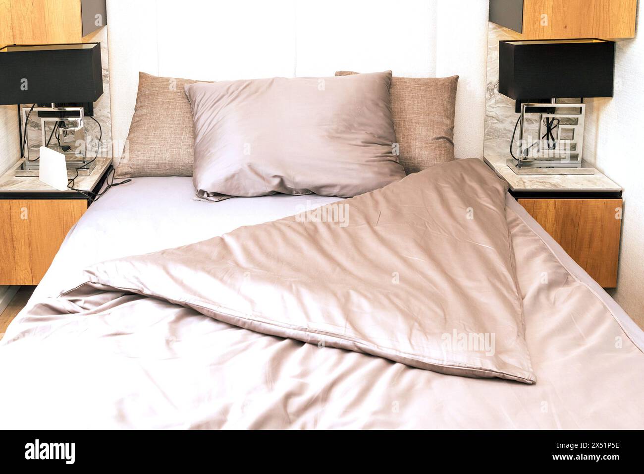 Hotel bed with cotton bedding inside room interior Stock Photo - Alamy