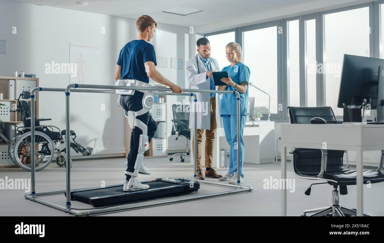 Modern Hospital Physical Therapy: Patient with Injury Walks on ...