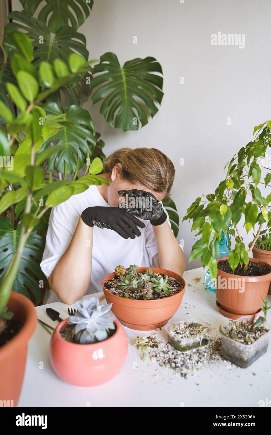 In a cozy room, a sad woman tends to her beloved plants with care ...