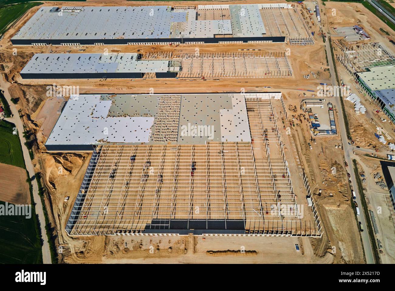 Aerial view of construction site with warehouse building under ...