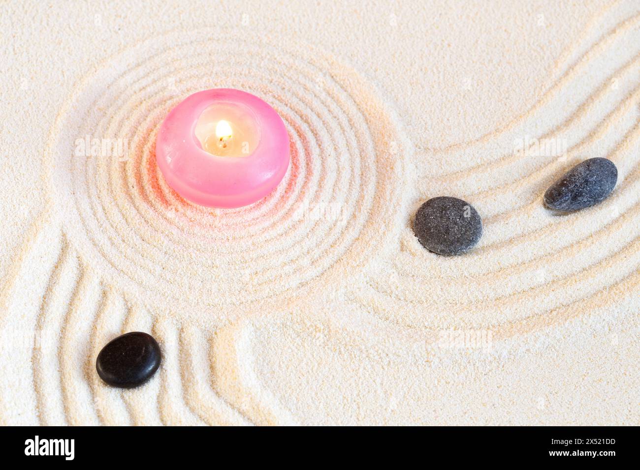 Zen garden with the sand, stones and the burning candle Stock Photo - Alamy