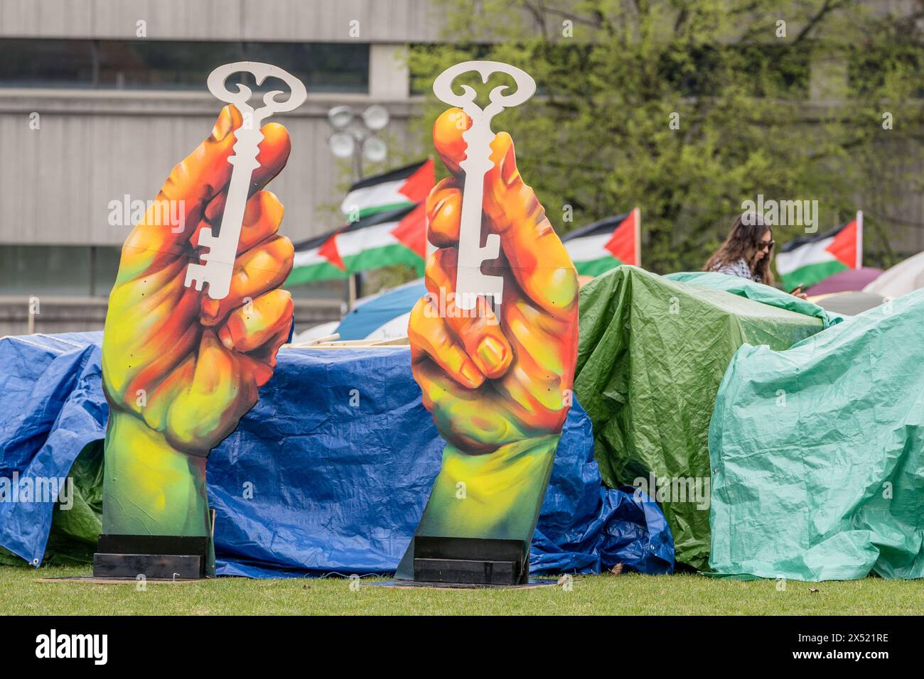 Hands holding two keys at encampment created by students occupying ... Hands holding two keys at encampment created by students occupying ...