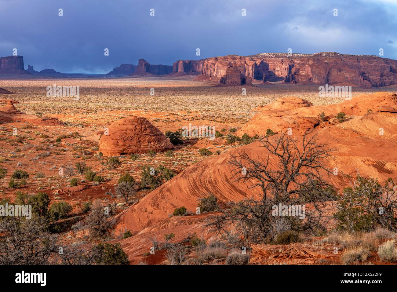 A hike into a remote area of Monument Valley Arizona during dusk shows ...