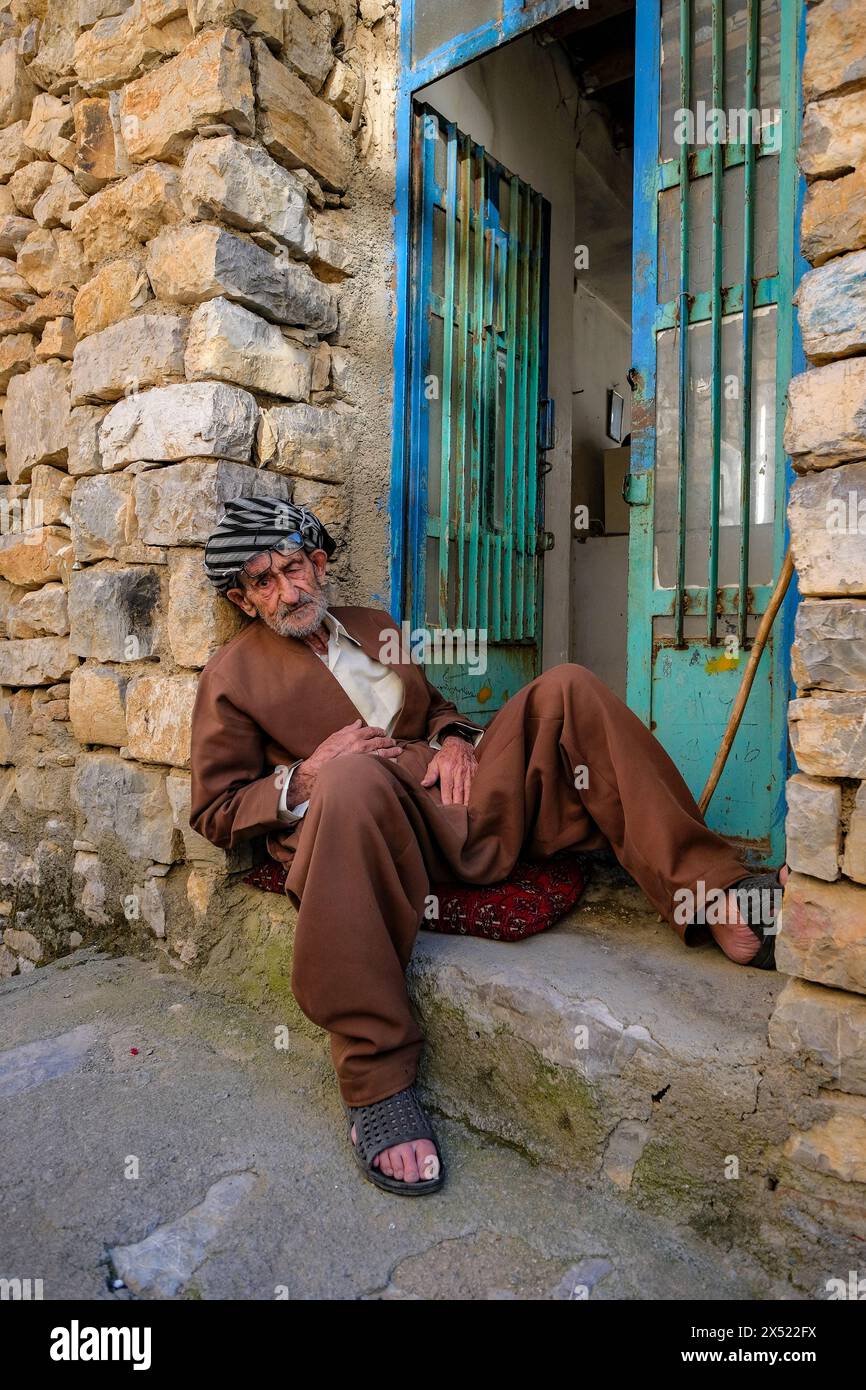 Uraman Takht, Iran - April 15, 2024: Portrait of a man sitting on a ...