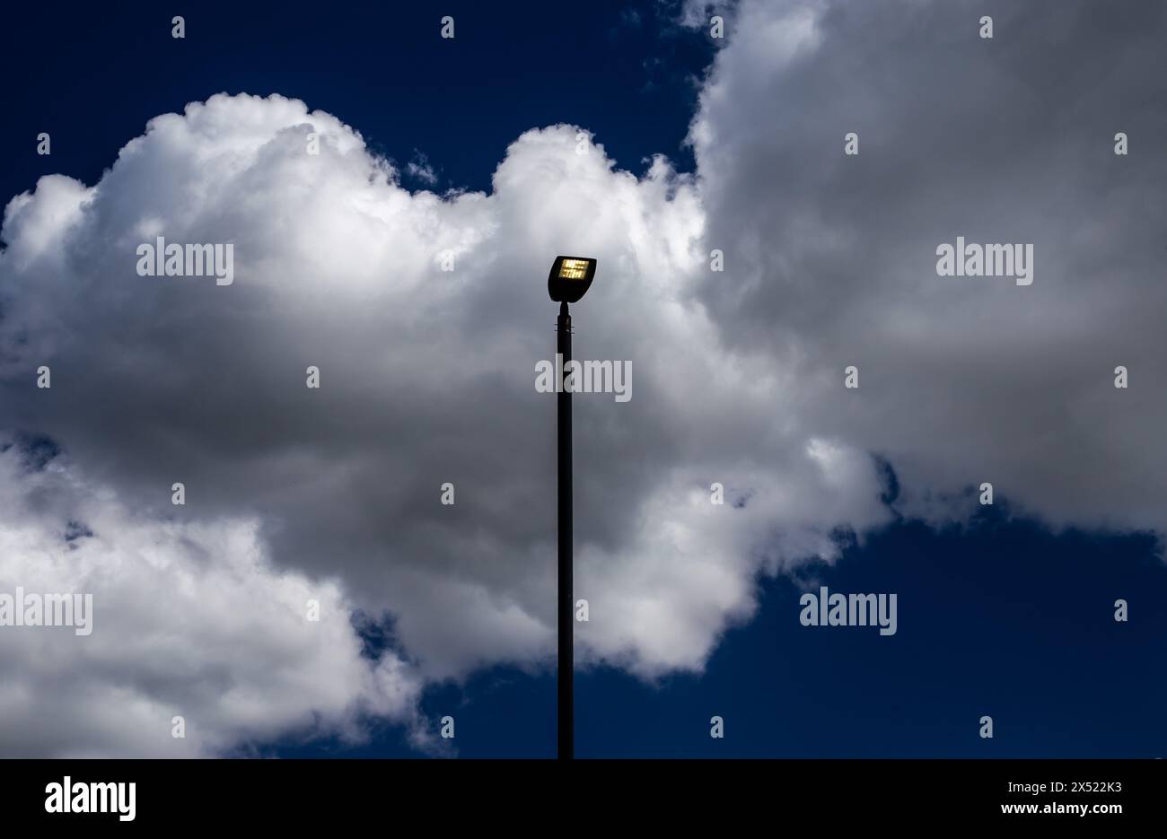 LED Lights on in the day time with dramatic blue sky and white clouds ...