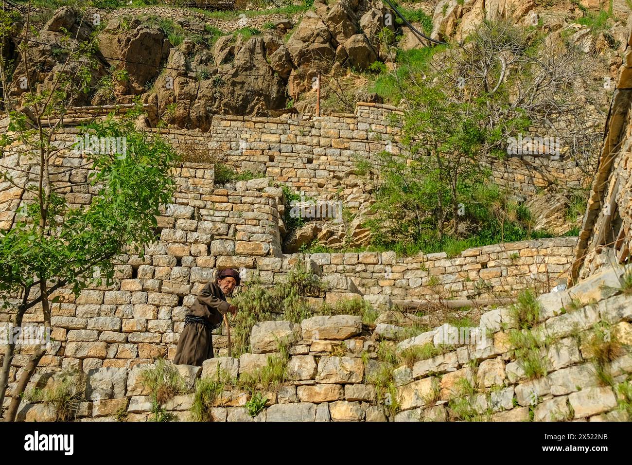 Uraman Takht, Iran - April 17, 2024: A man walking down a street in ...