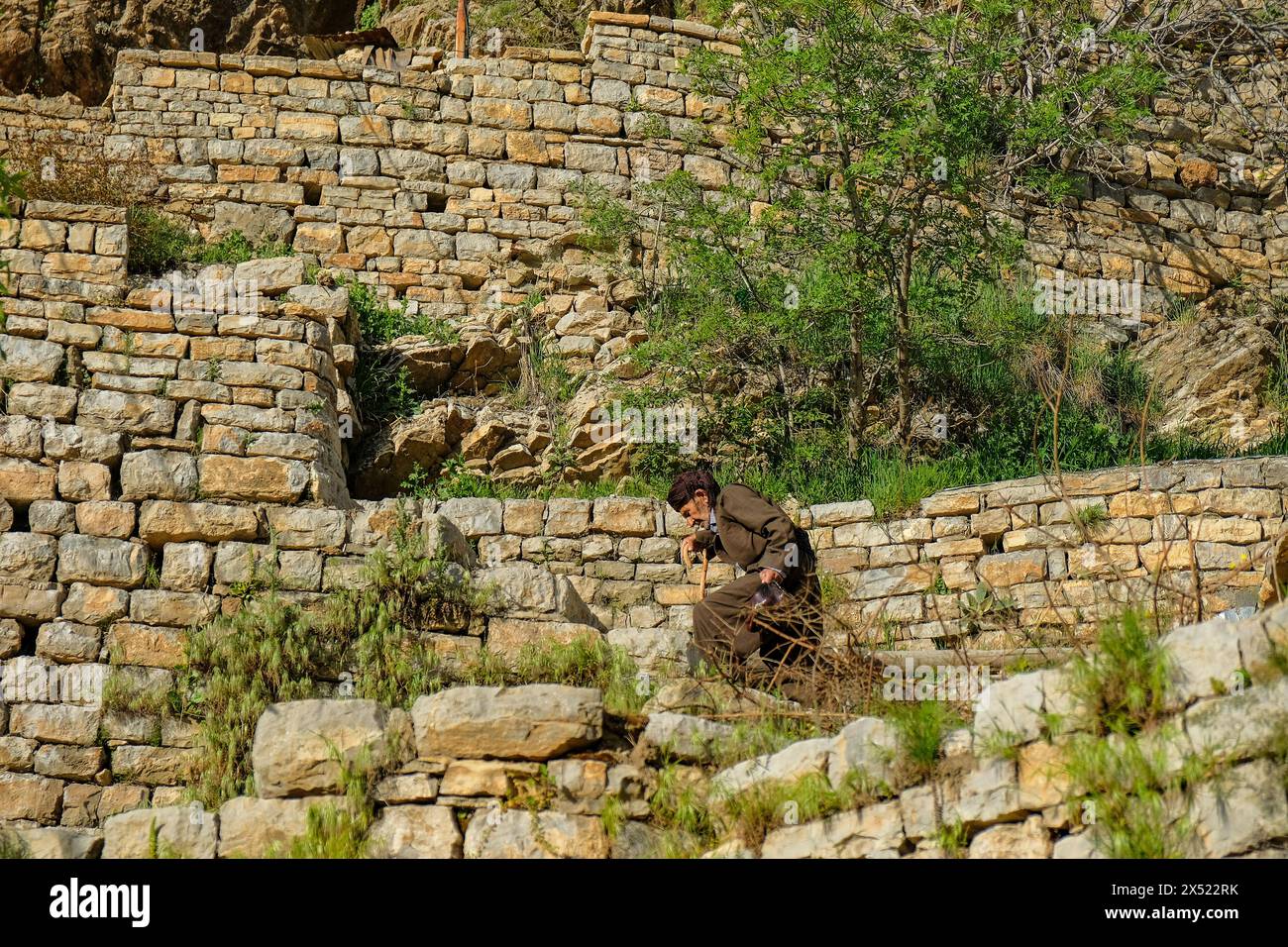 Uraman Takht, Iran - April 17, 2024: A man walking down a street in ...
