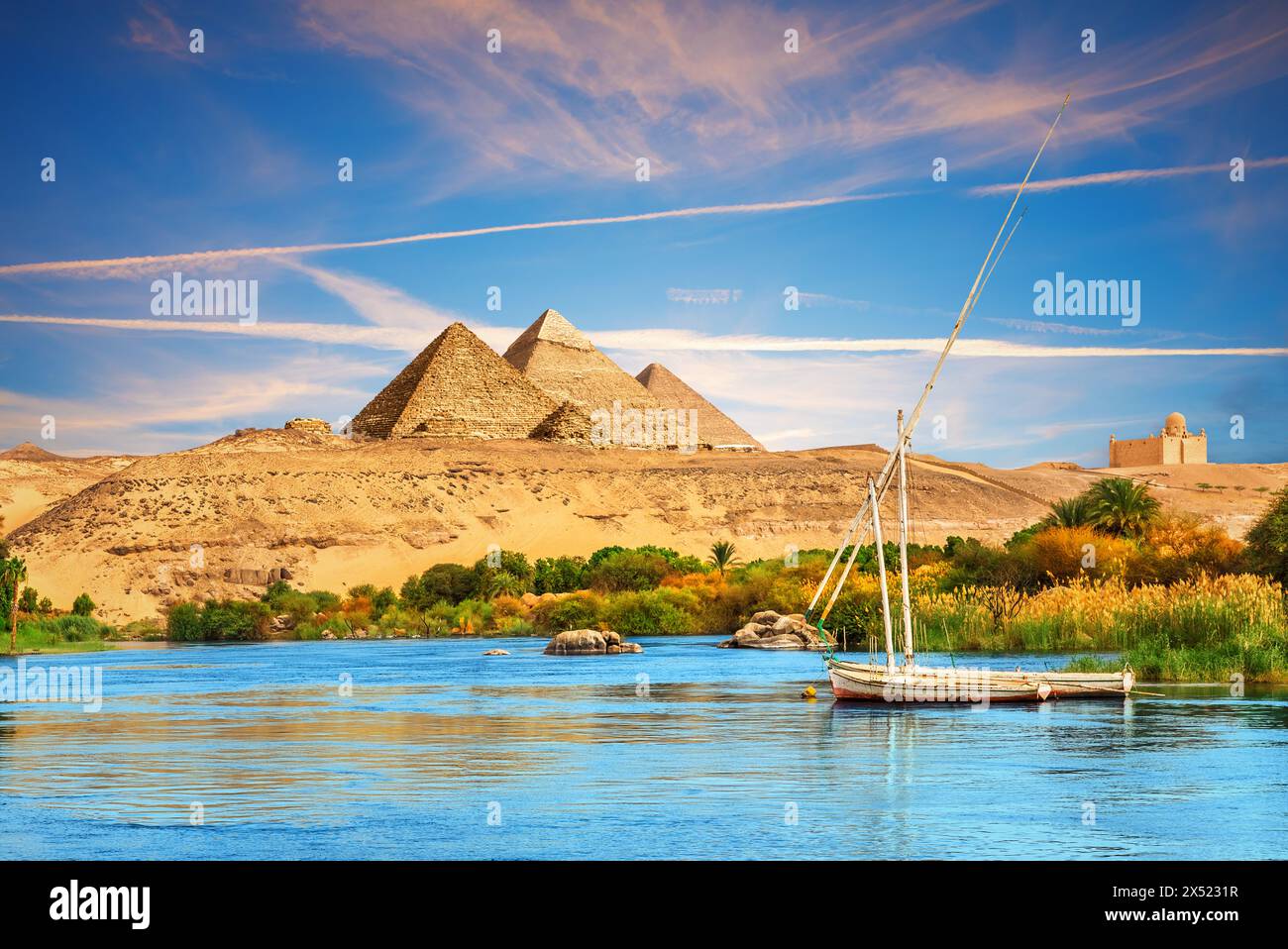 View on the Nile and the boats in the Aswan desert by the pyramids ...