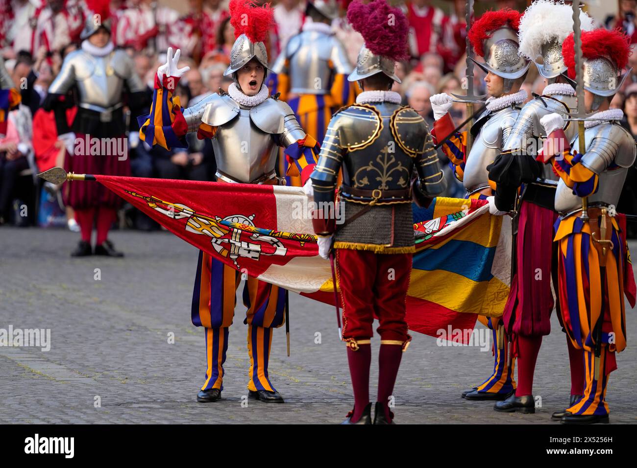 Vatican Swiss guards, one of them holding up his right arm and showing ...