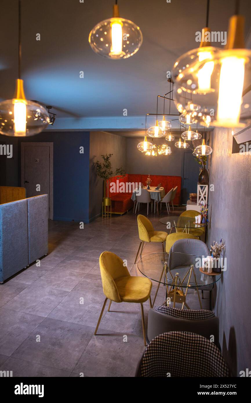 Elegant restaurant with dim lighting, stylish furniture, dark walls ...
