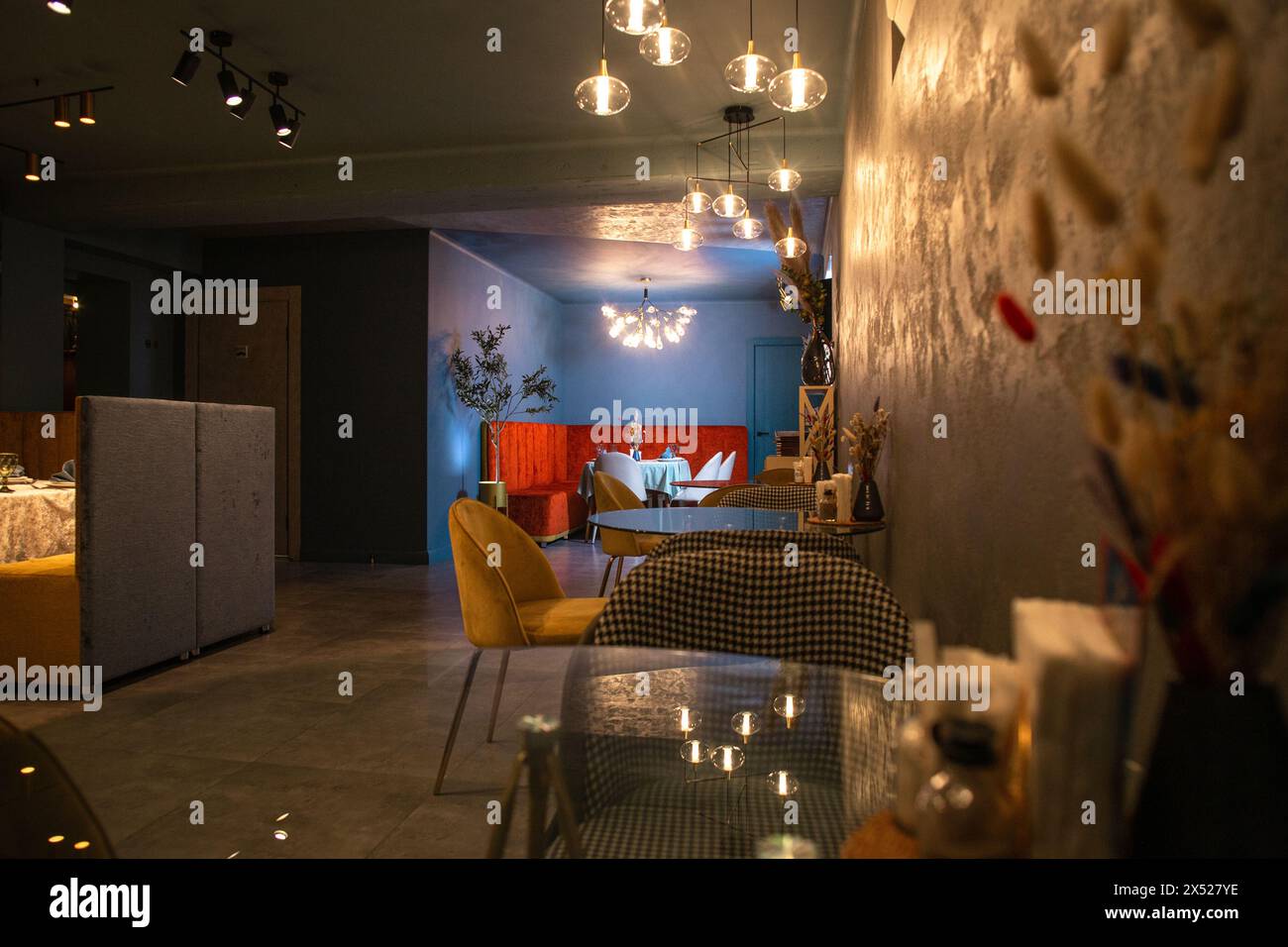 Elegant restaurant with dim lighting, stylish furniture, dark walls ...