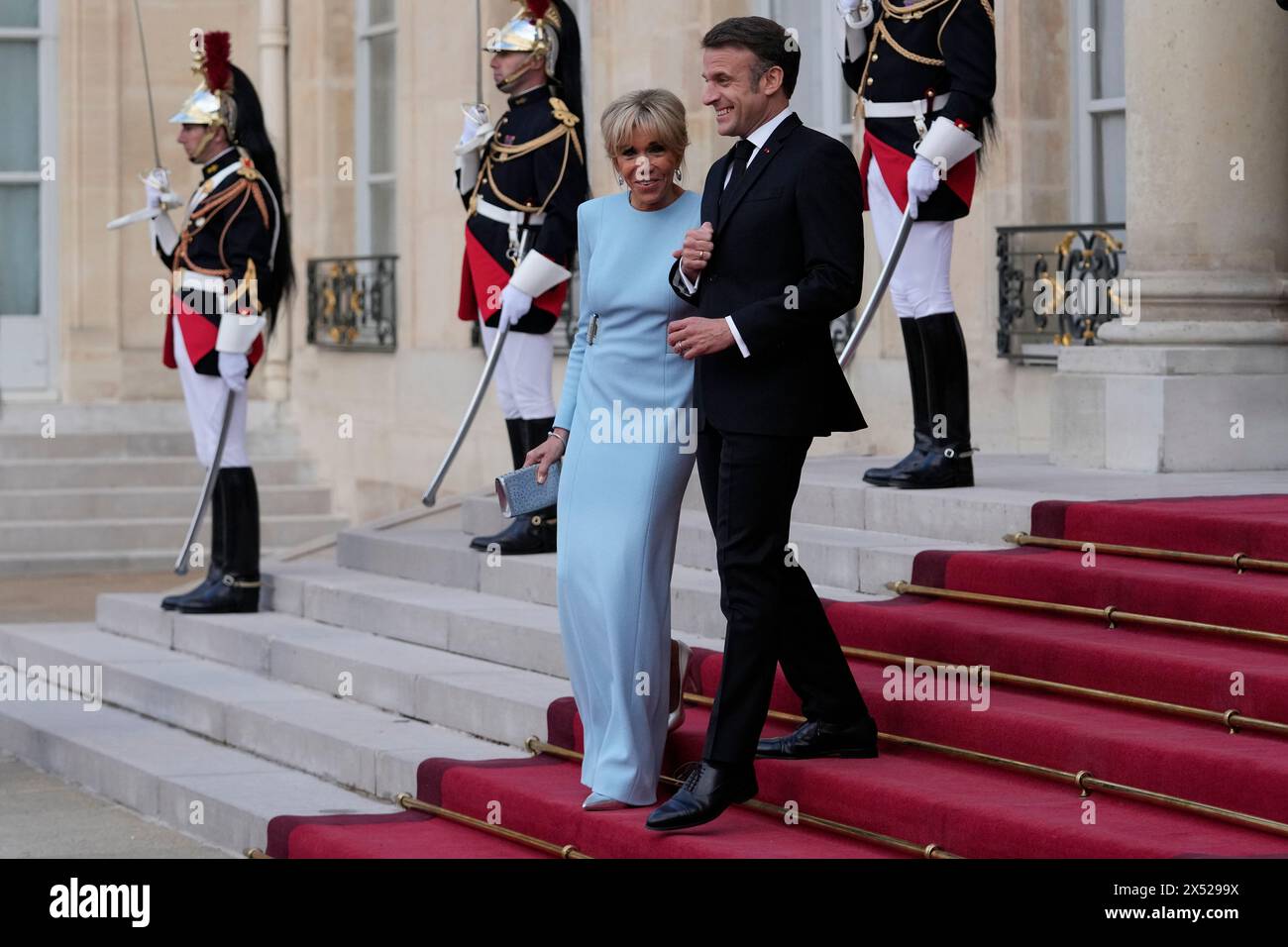 French President Emmanuel Macron and his wife Brigitte Macron walk to ...