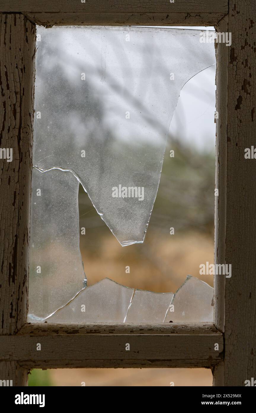 Glass broken by hooligans in a metal-plastic window, close-up. 2 Stock ...