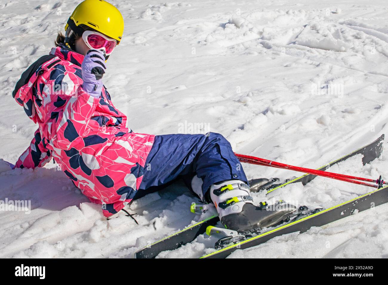young skier is resting on a ski slope. Active recreation. Healthy ...
