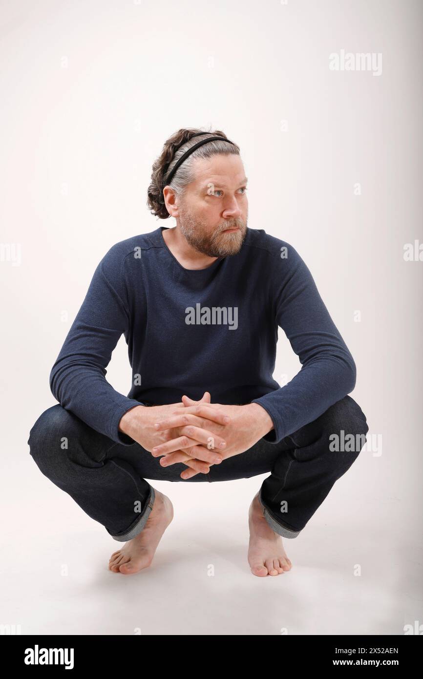Squatting stretching hi-res stock photography and images - Alamy