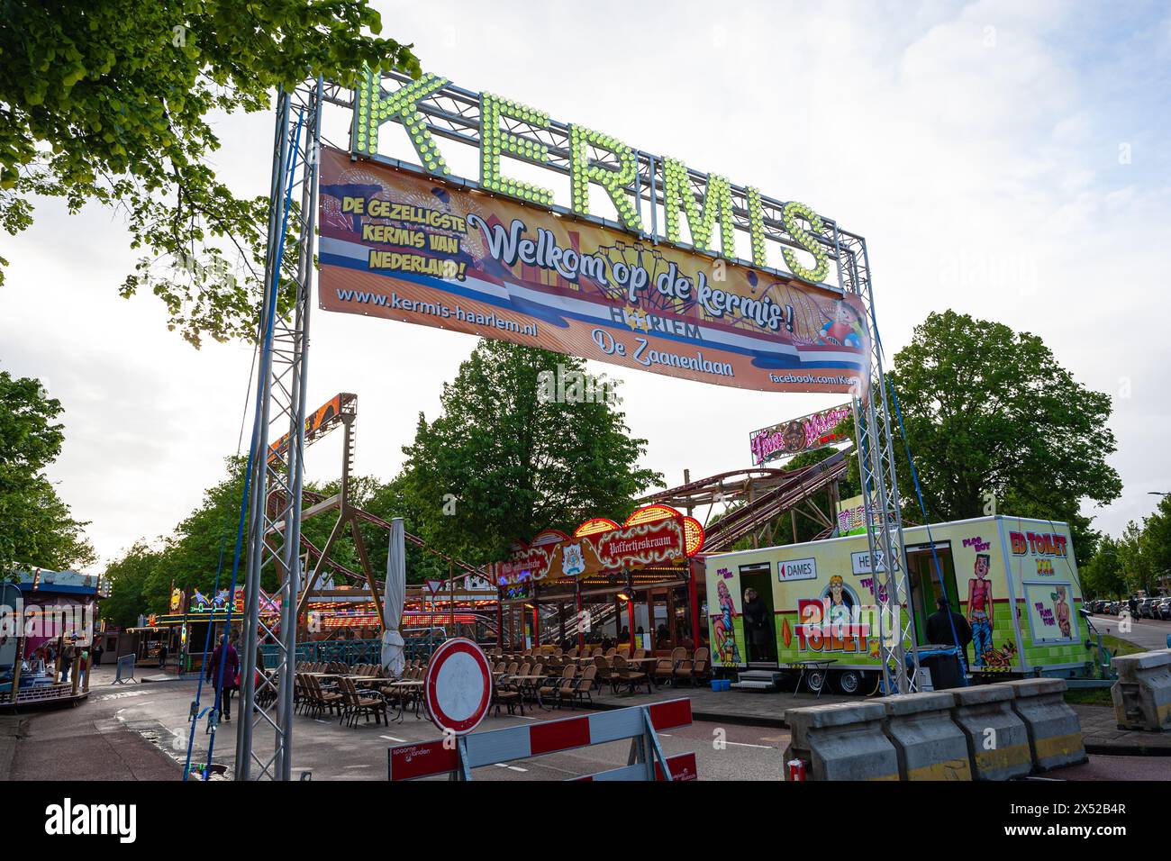 Entrance to a fairground with numerous attractions in city of Haarlem ...