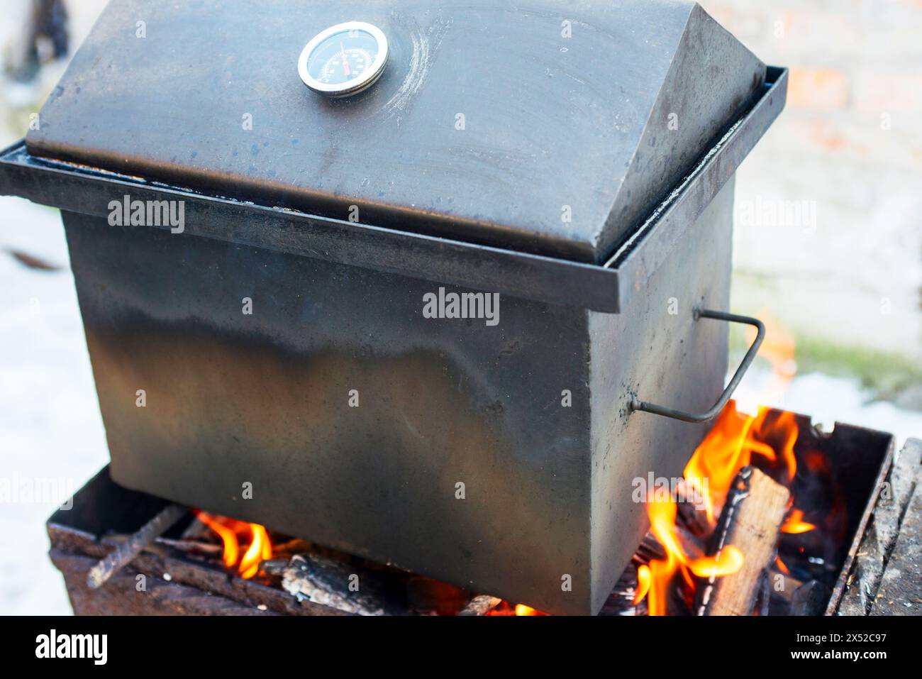 Outdoor Smoker on Fire Cooking Food Stock Photo - Alamy