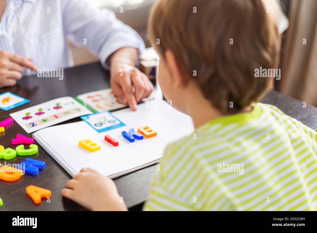 Child Learning Letters with Colorful Magnets Stock Photo - Alamy