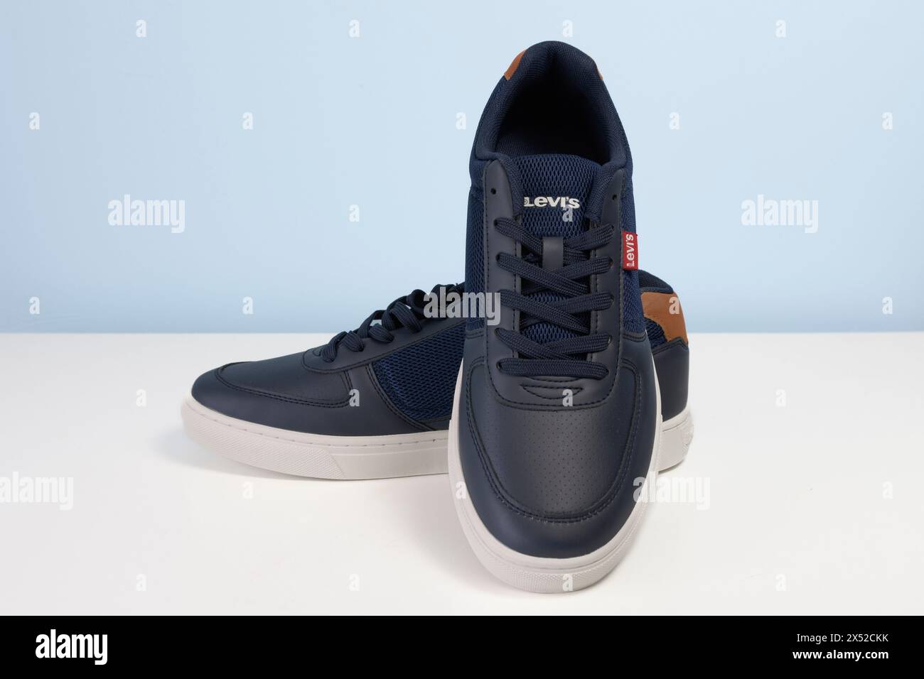 Sneakers LEVIS model LIAM navi blue. Front side view on blue background ...