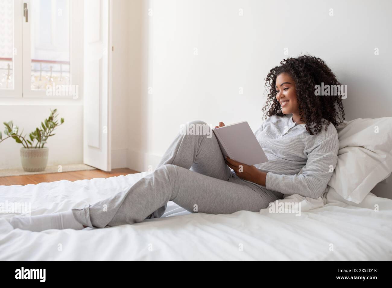 Woman Sitting on Bed, Writing a Diary Stock Photo - Alamy