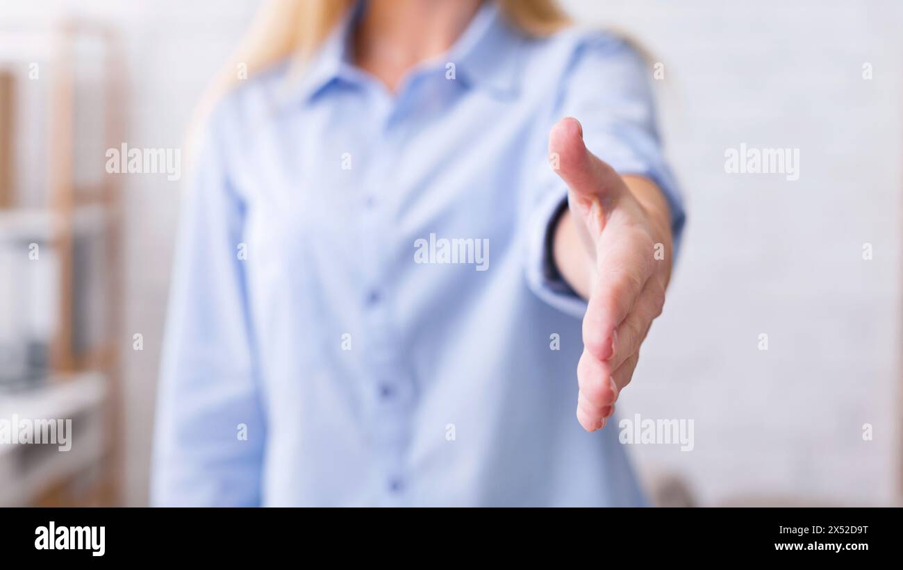 Female helping hand extended at camera for handshake Stock Photo - Alamy