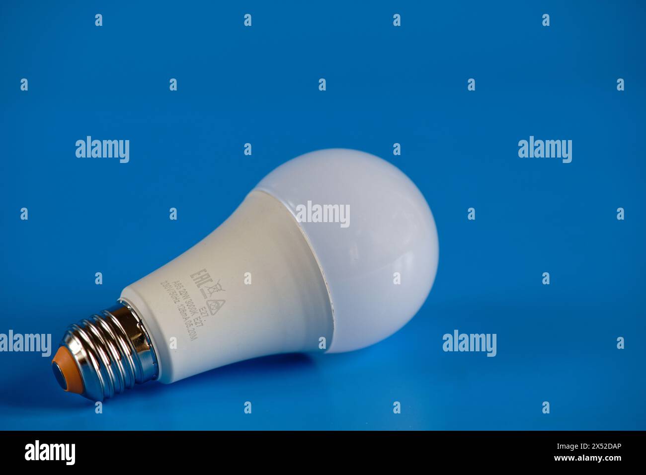 Energy-saving LED light bulb on a blue background Stock Photo - Alamy