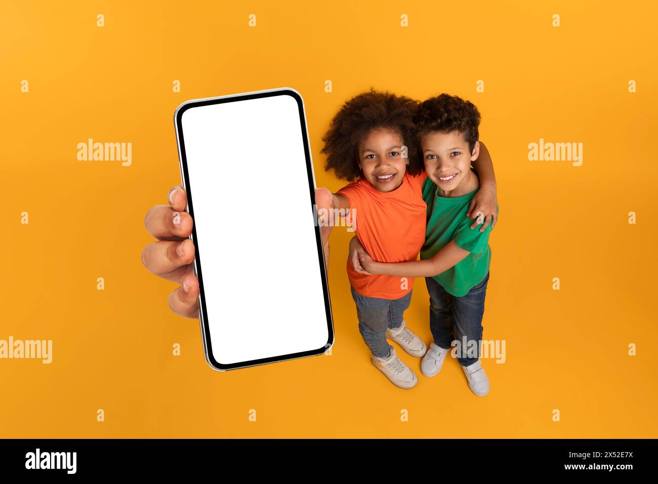Kids Holding Up Cell Phone With White Screen Stock Photo - Alamy