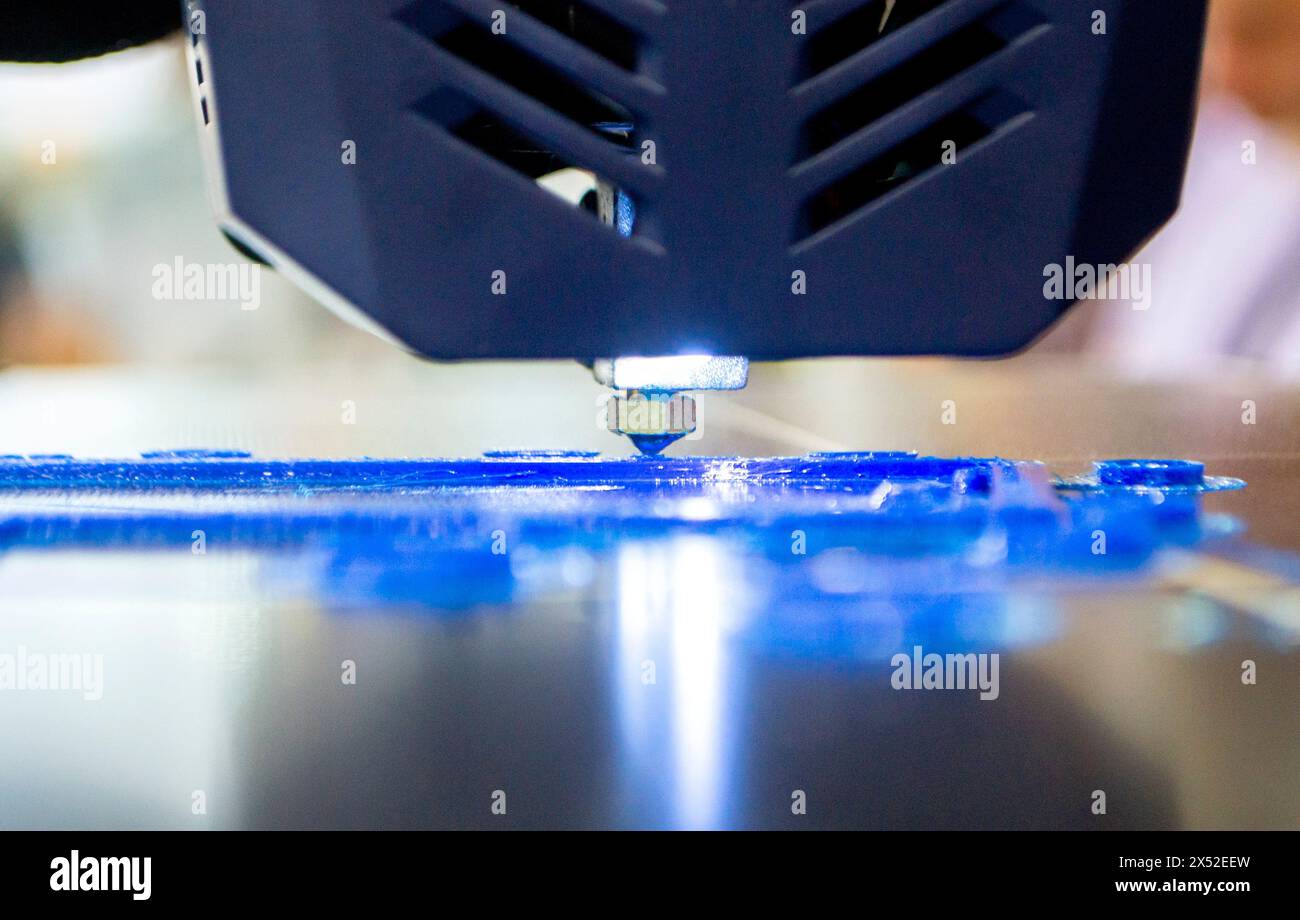 3D printer working close-up. 3D printer prints a model from molten ...