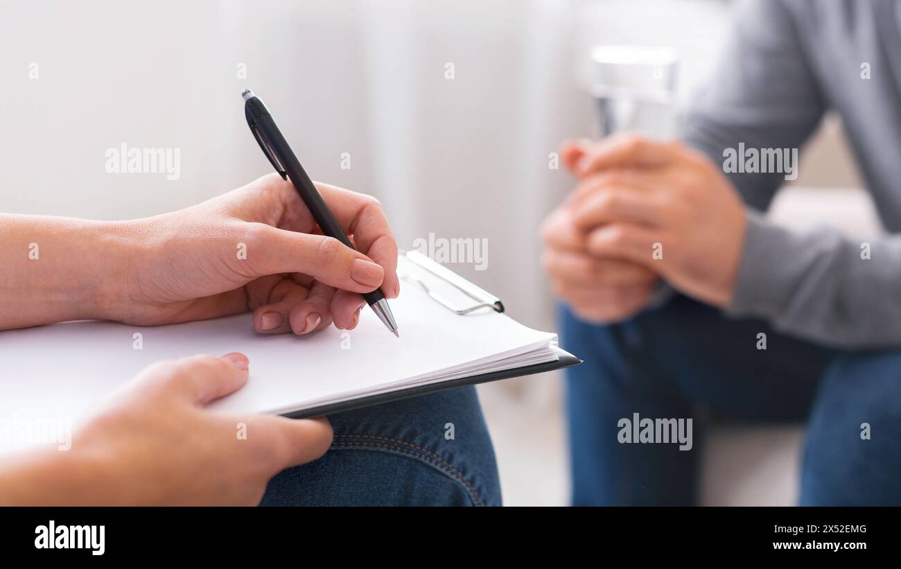Therapist taking notes in counselor hi-res stock photography and images ...