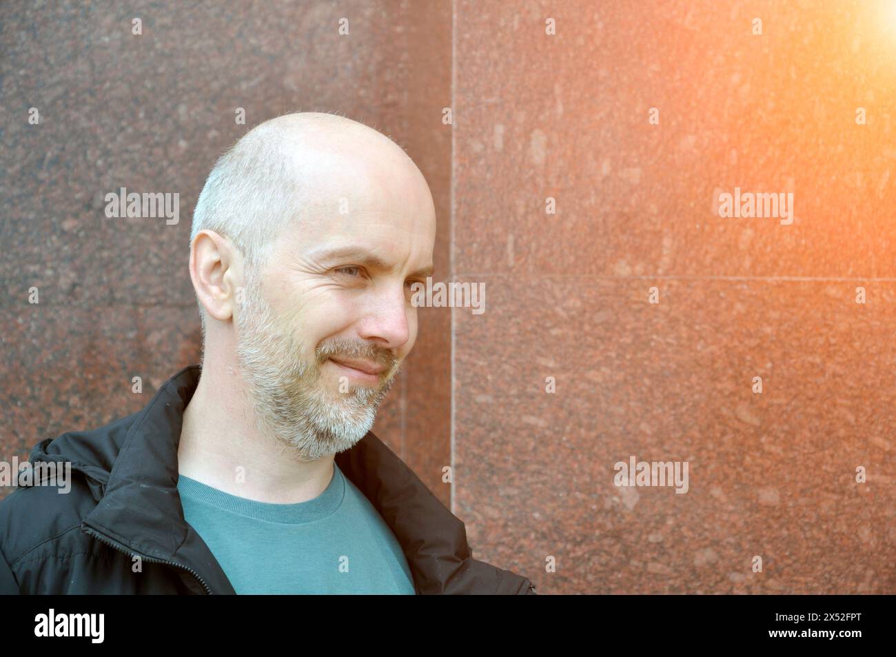 Close-up portrait of a smiling unshaven village guy in dirty clothes ...