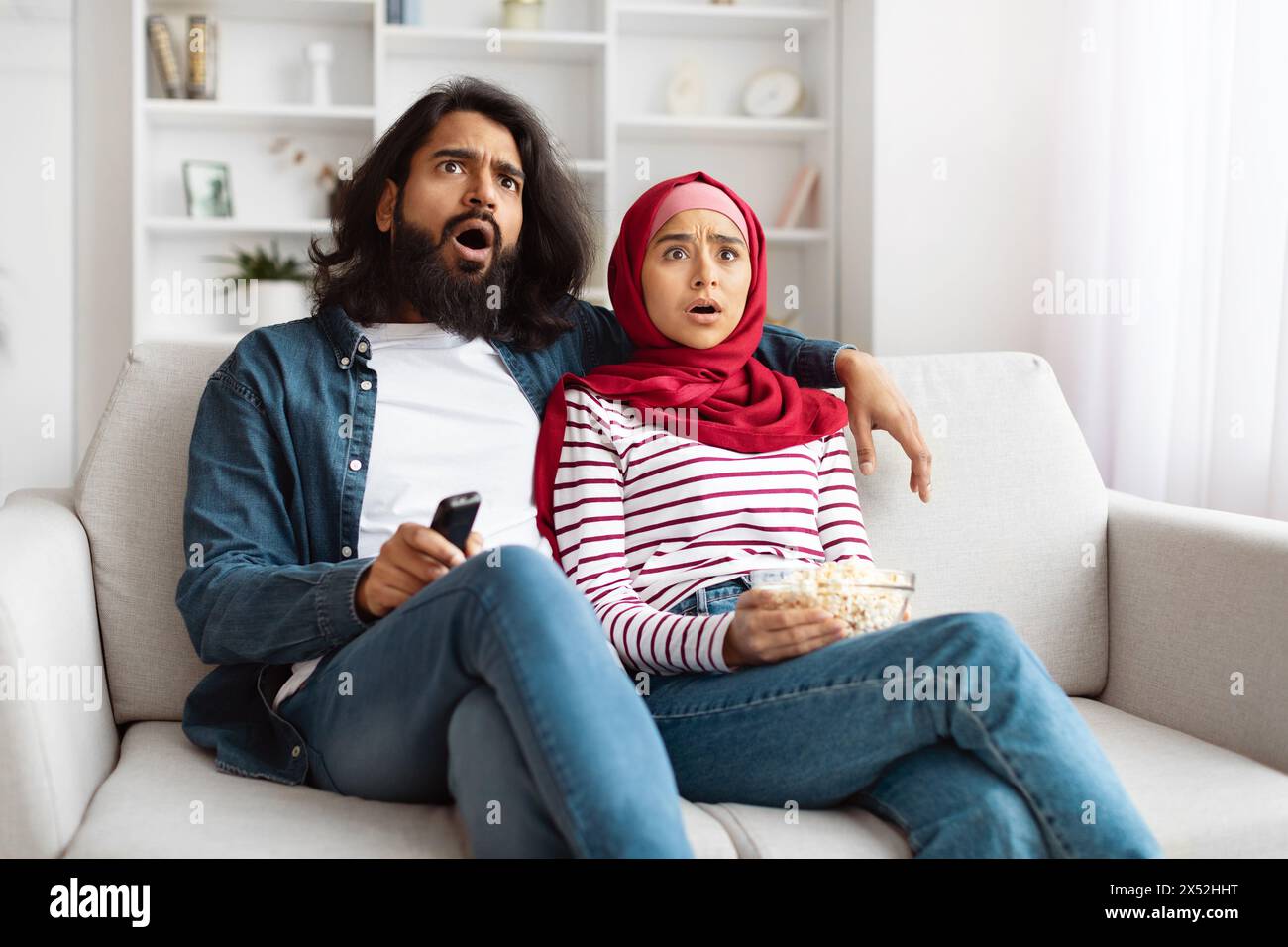 Couple Reacts With Shock and Surprise While Watching Television Stock ...