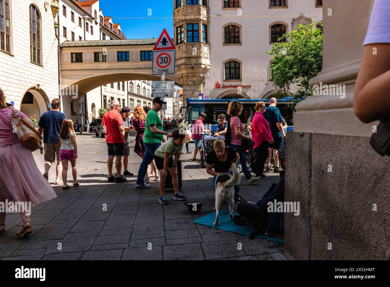 Munich, Germany - July 22, 2023: People feed homeless man and his dog ...