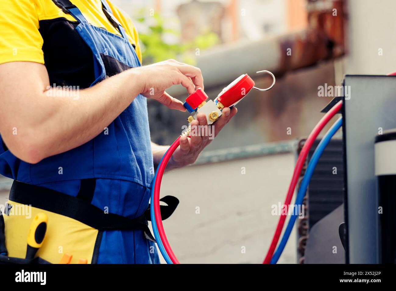 Experienced wireman doing annual air conditioner maintenance ...