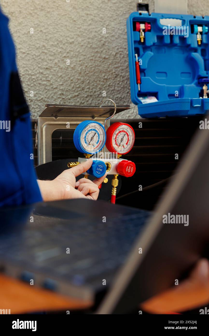 Licensed serviceman calibrating set of barometer meters during ...