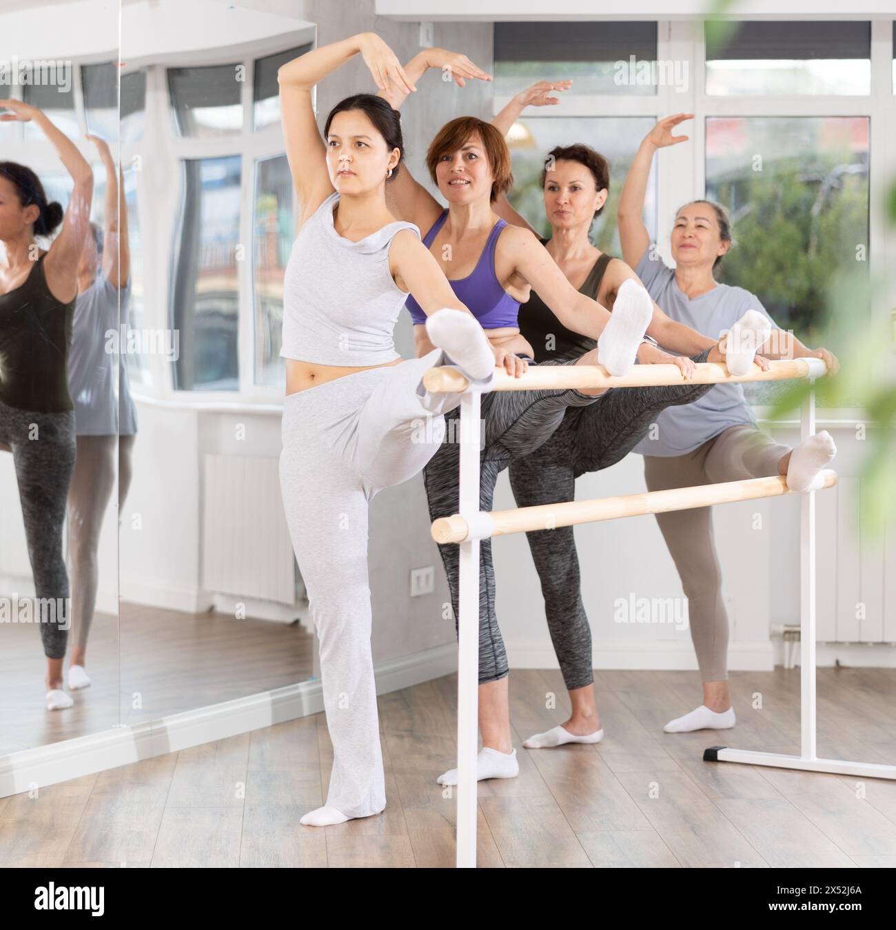 Ballet pose grand batman - women of different ages at choreography ...